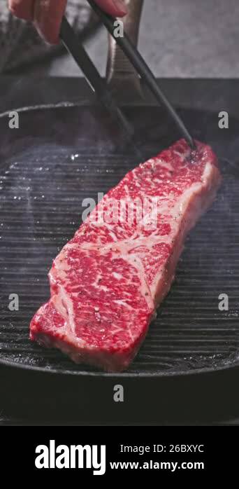 delicious juicy wagyu beef steak meat cooking on a grill pan. Process ...
