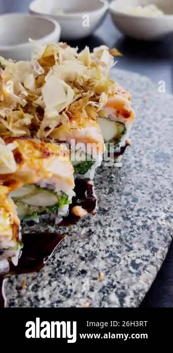 Luxury sushi rolls with salmon, fried fish, truffle oil, bonito and ...