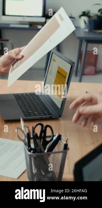 Vertical shot of busy working process of group of unrecognizable ...