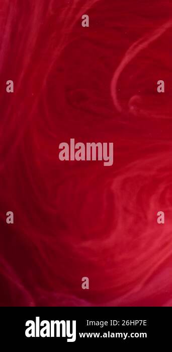 Vertical video. Color vapor swirl. Ink water vortex. Blur red glowing ...