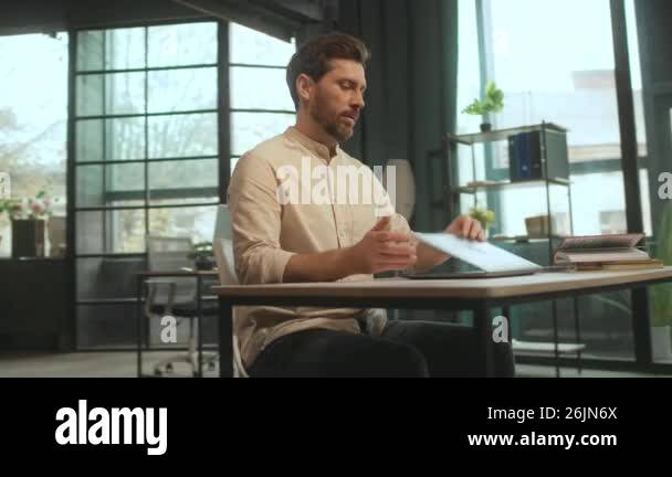 Smiling man sitting at desk closed laptop feel happy and thinking in ...