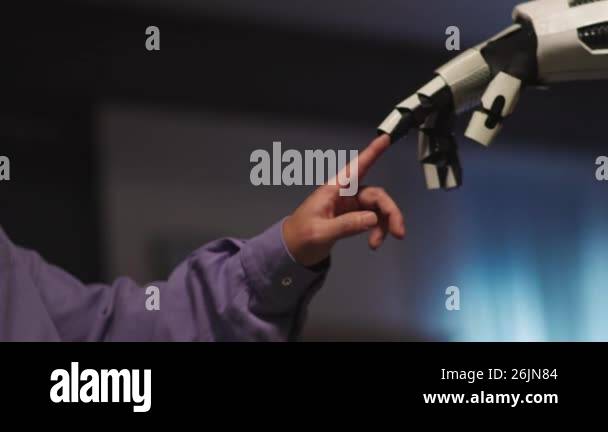 Close-up hand of unrecognizable man touching finger of white robot ...