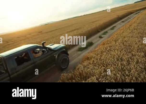 Drone footage of armored military pickup truck riding by straight ...