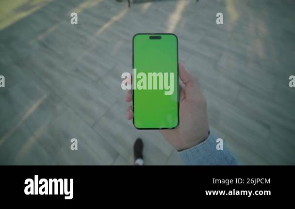 Outdoors view on hand man holding and scrolling vertically phone with ...