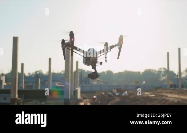 Footage of modern drone with camera conducting detailed site surveys ...