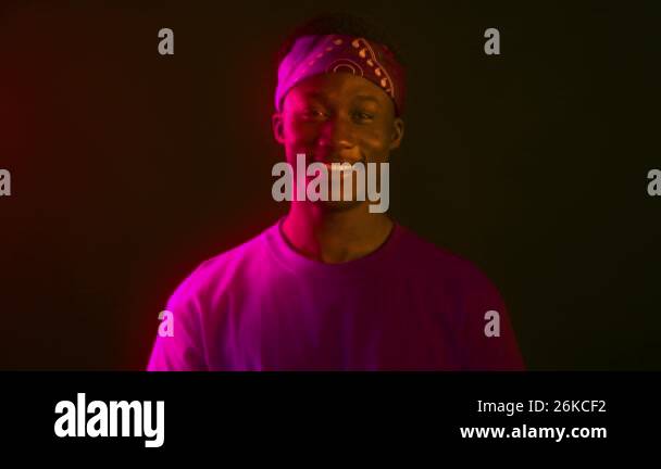 A stylish African American man is smiling confidently, wearing a ...