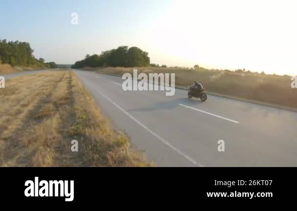 Follow to motorcyclist in helmet riding on sport motorbike at highway ...