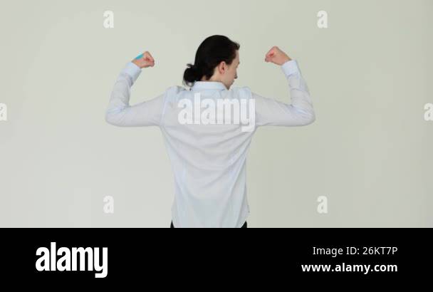 Back view of man in shirt raising arms demonstrating biceps muscle ...