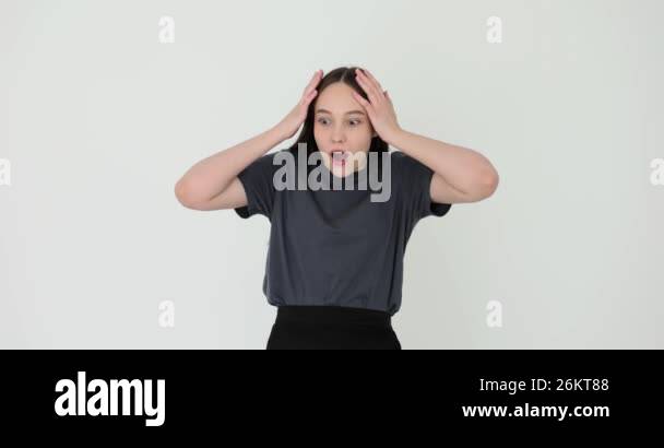 Young woman expressing shock and surprise on white background. Emotions ...