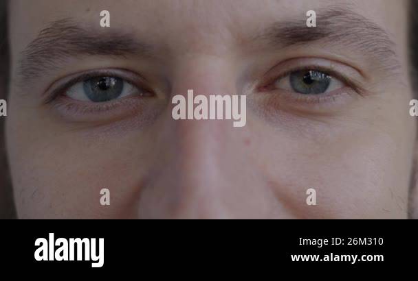 Close-up portrait of male eyes looking at camera with happy expression ...