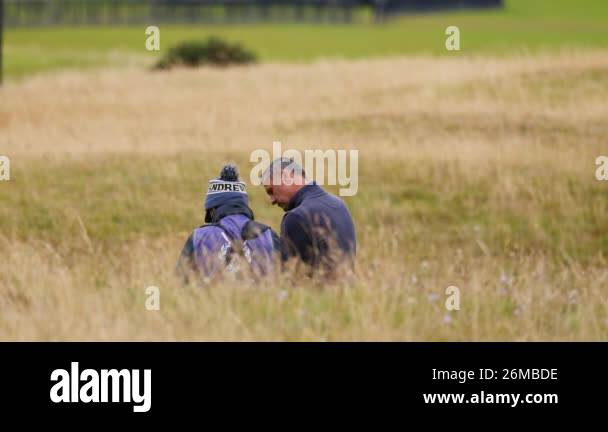 Two people in conversation on golf course Stock Video Footage - Alamy