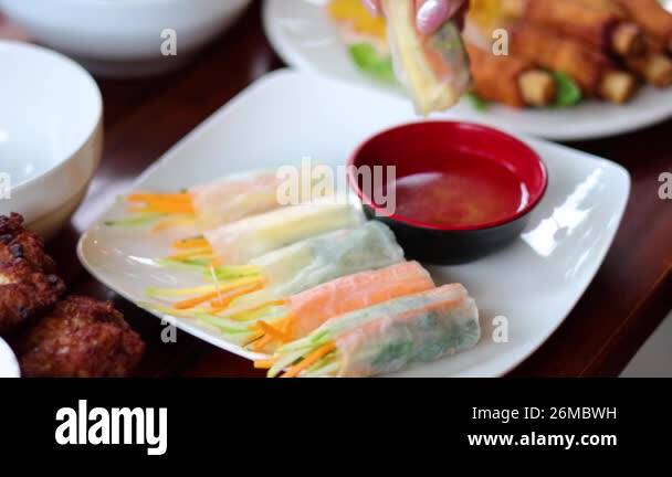 Hand dipping a spring roll into sauce repeatedly Stock Video Footage ...