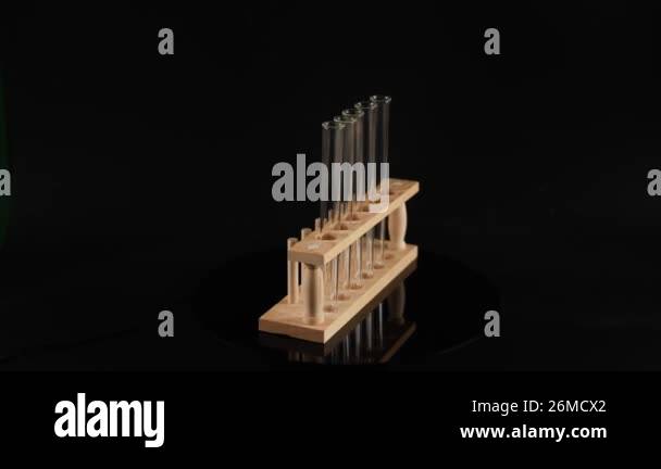 Wooden test tube rack rotating on black background Stock Video Footage ...