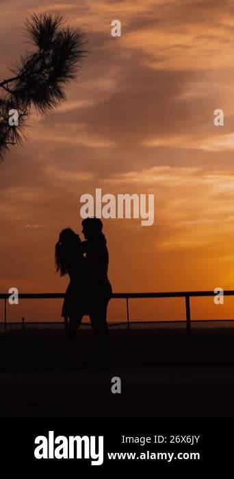 Young Couple silhouette at the beach of black sea kissing dancing and ...