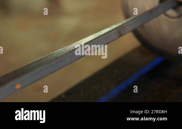 Twisted metal square rod. The rod is placed in a hydraulic torsion ...