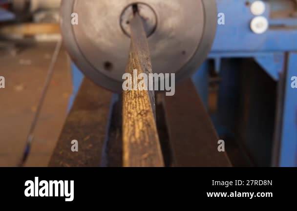 Twisted metal square rod. The rod is placed in a hydraulic torsion ...