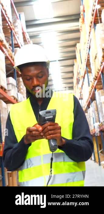 Efficient warehouse worker scanning packages with barcode scanner ...