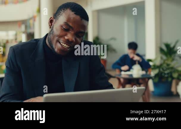 Portrait of African American man nodding head while speaking on phone ...