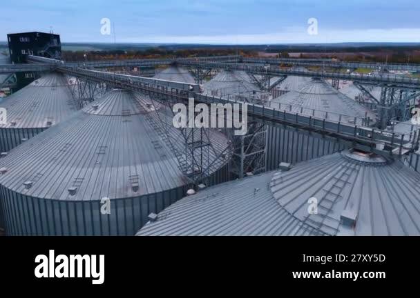 Metal construction connecting large silo tanks at the tops. Drone ...