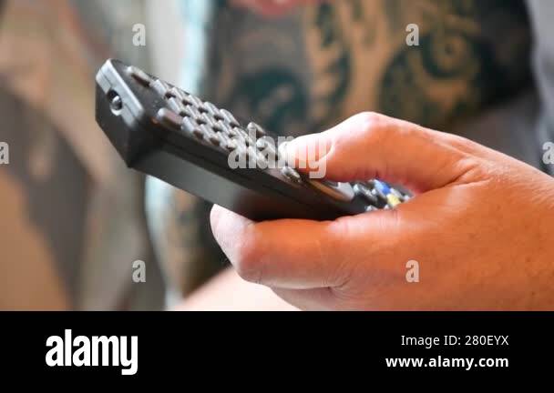 Using the remote control to change channels Stock Video Footage - Alamy
