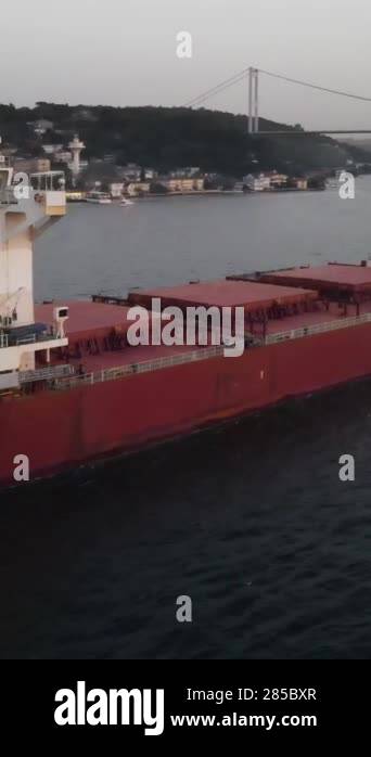 Drone view of an empty container ship crossing the strait, transport ...
