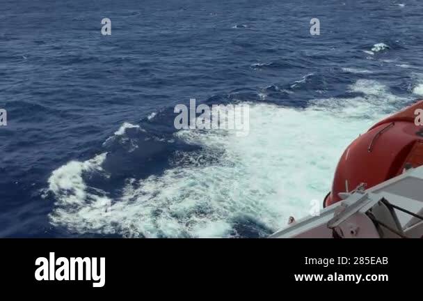 Large, slow-moving waves roll across the open sea, capturing the ...