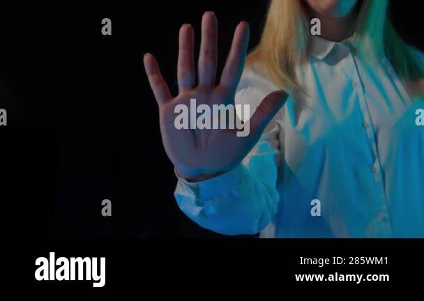 Computer technology and cyberspace security. Woman touches glass screen panel, open palm print ...