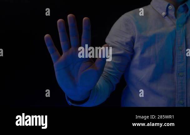 Computer technology and cyberspace security. Man touches glass screen panel, open palm print on ...