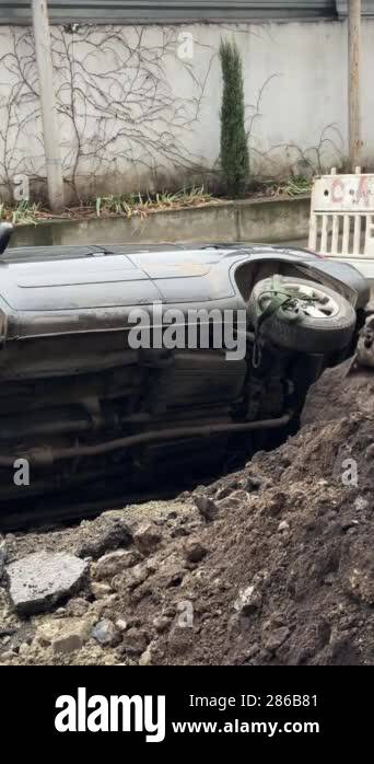 Accident on the road: a passenger car has fallen through the asphalt ...
