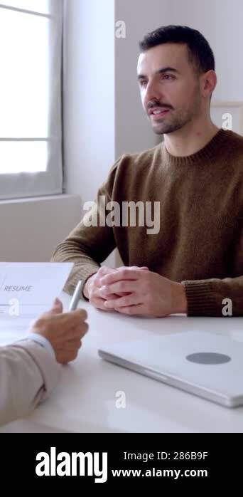 Vertical HD video of young man doing a job interview with senior female ...