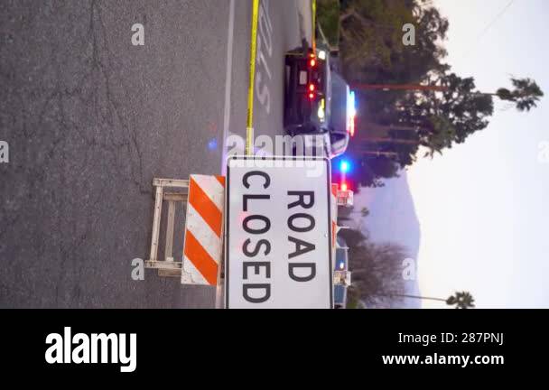 Vertical. A detailed scene of a road closure enforced by law ...