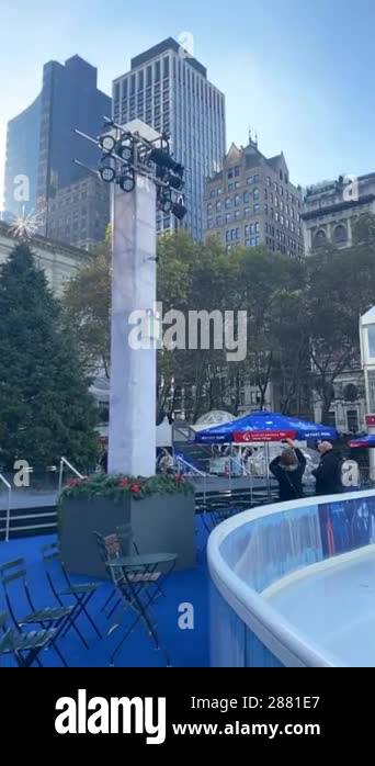Ice rink workers clean ice from water in the Bryant Park, Manhattan ...