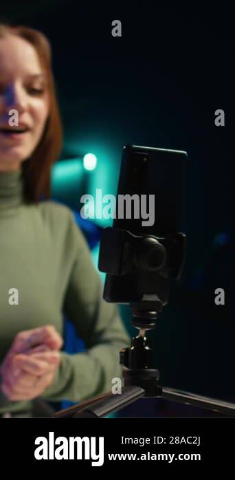 Vertical video Young content creator records introductory video with ...