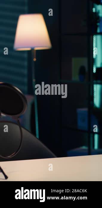 Vertical video Smiling influencer entering living room used as ...