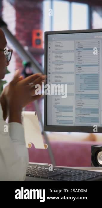 Vertical video Jolly engineer in home office working on computer ...