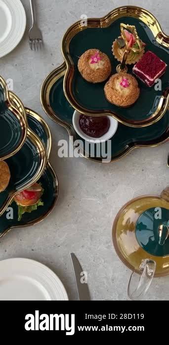 Elegant afternoon tea setup, complete with tiered trays of fresh ...