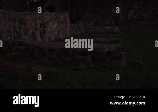 Dimly lit medieval castle ruins with ancient stone masonry foundations ...