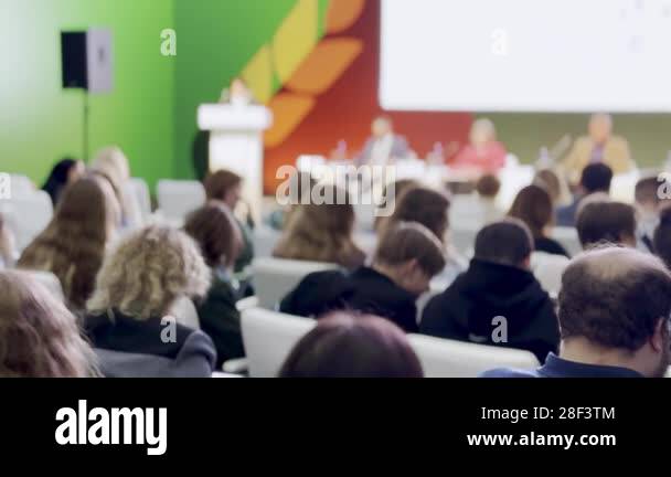 Large audience attending business conference and listening to speakers ...