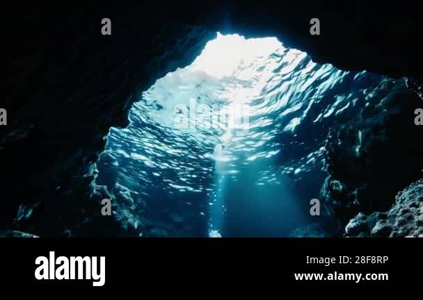 A stunning underwater cave scene lit by warm sunlight, highlighting ...