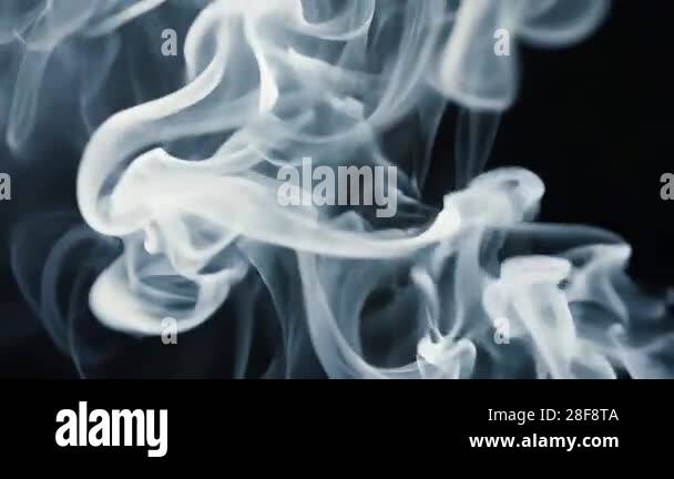 A stunning image of ethereal white smoke patterns dancing gracefully ...