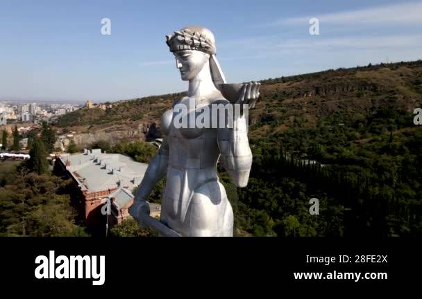 The Kartlis Deda statue in Tbilisi, Georgia, stands tall with a bowl ...