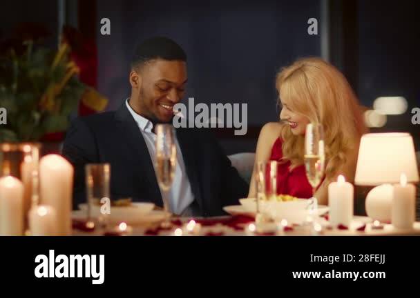 A young diverse couple shares affectionate moments during a romantic ...