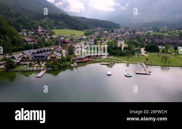 A picturesque Austrian village by a lake, featuring traditional houses ...
