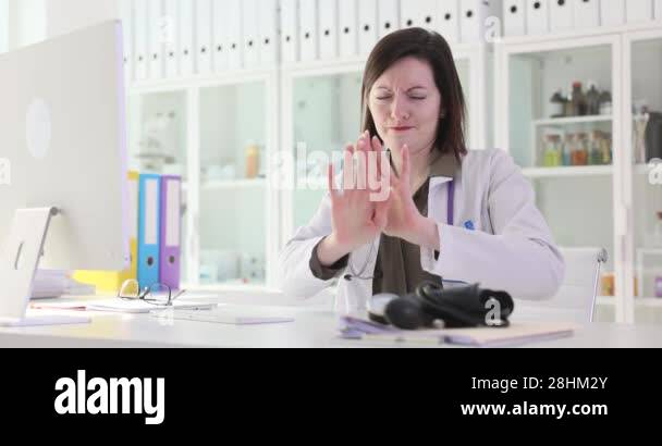 Doctor waves hands and shakes head indicating disagreement with ...