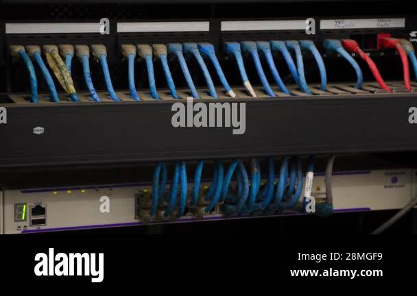A close-up of a data center server rack featuring flashing indicator lights and organized ...