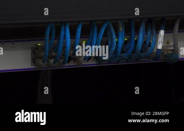A close-up of a data center server rack featuring flashing indicator lights and organized ...