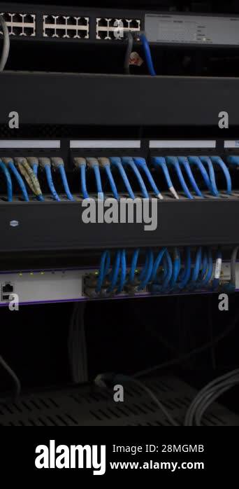 A close-up of a data center server rack featuring flashing indicator lights and organized ...