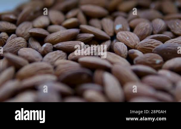 Close-up, heap of fresh almonds in close detail. Natural brown tones ...