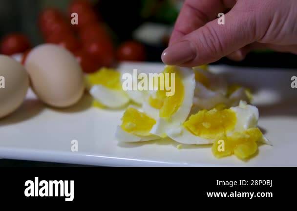 Close-up of hands removing the golden shell from a hard-boiled Easter ...