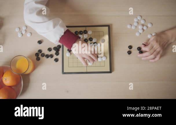 Close-up and top-view shots of Go, oriental checkers board game on ...